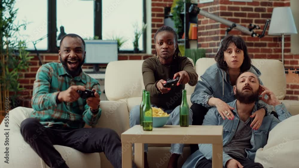 Multiethnic group of friends playing video games together, gaming ...