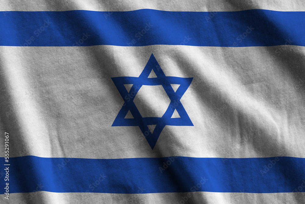 Israel flag with big folds waving close up under the studio light ...