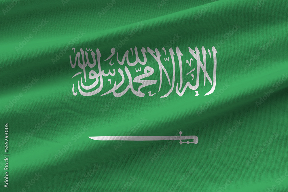 Saudi Arabia flag with big folds waving close up under the studio light ...