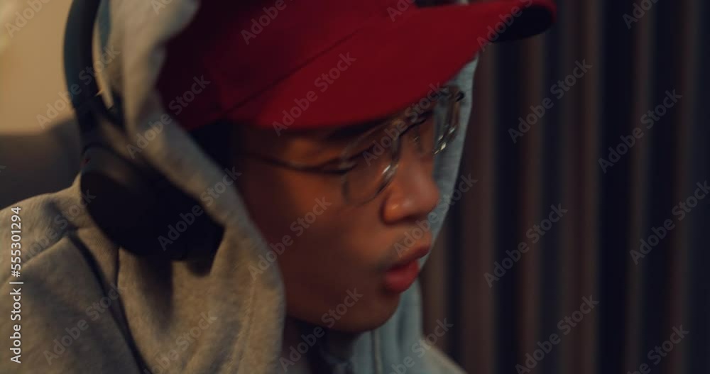 Close-up Young Asian man gamer wear gray hoodie red cap and headphone ...