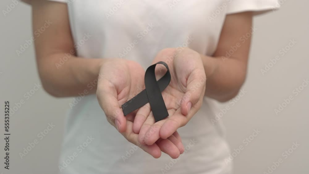 Woman holding black Ribbon for Melanoma and skin cancer, Vaccine injury ...
