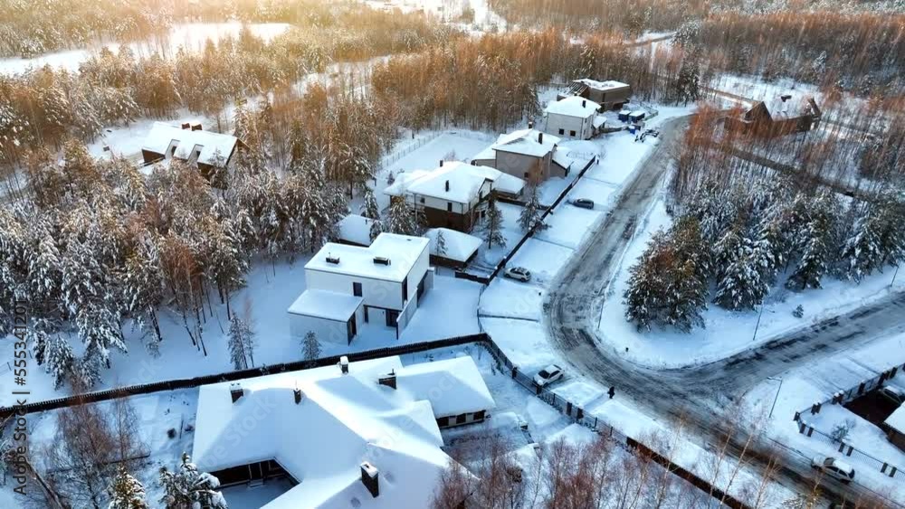 Cottage in winter sunset, aerial. Winter in town. Townhouse and ...