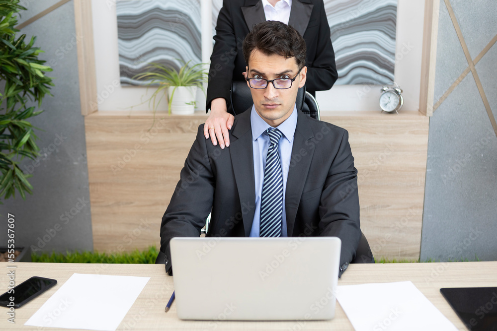 Young handsome man feeling discomfort because of his female boss ...