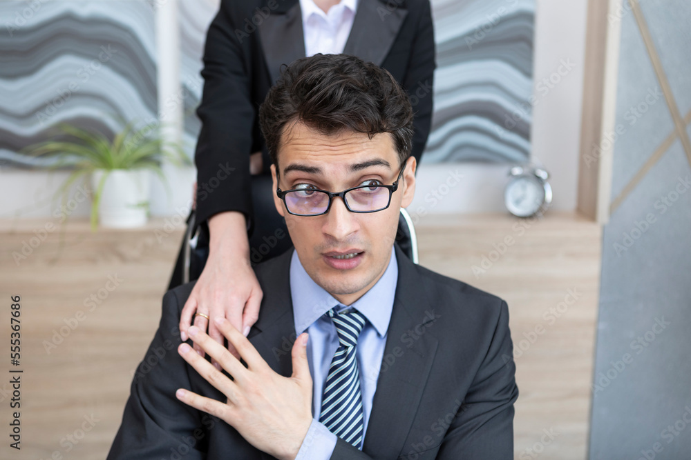 Young handsome man feeling discomfort because of his female boss ...