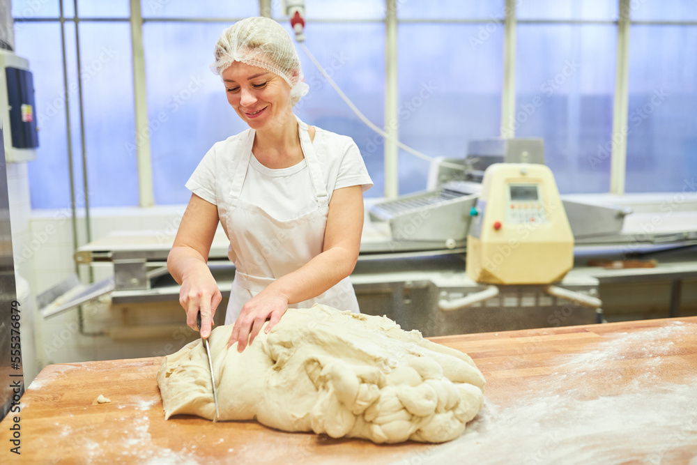 Baker apprentice in training kneading dough Stock Photo | Adobe Stock