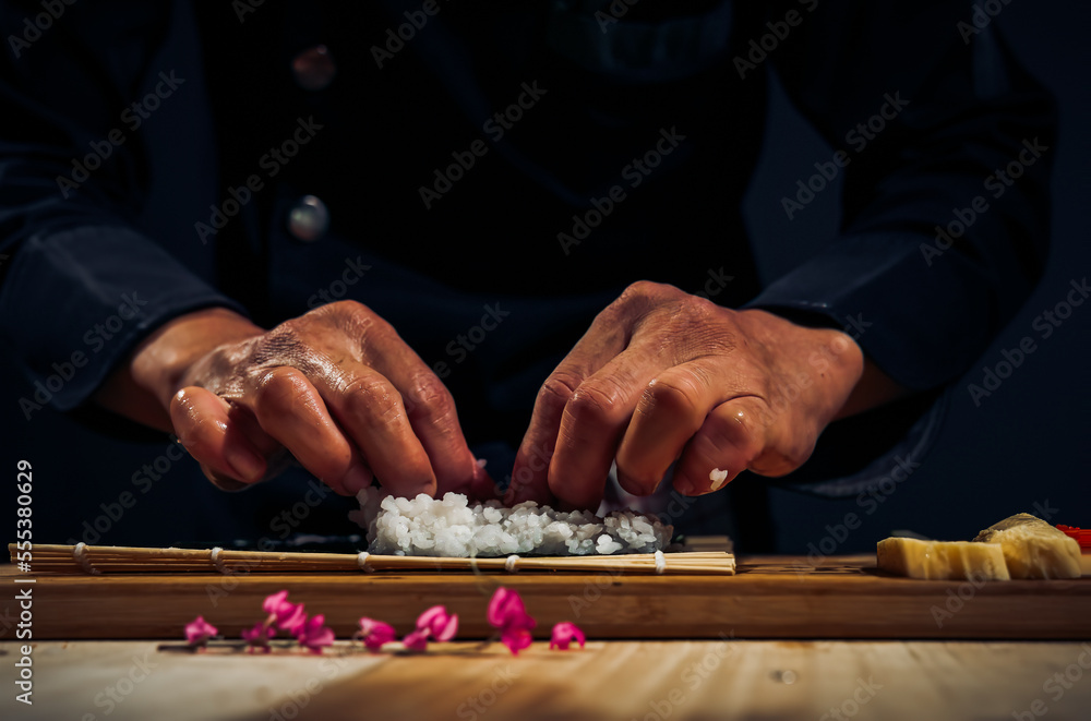 Japanese chef making California Maki Sushi with Masago - Roll made of ...
