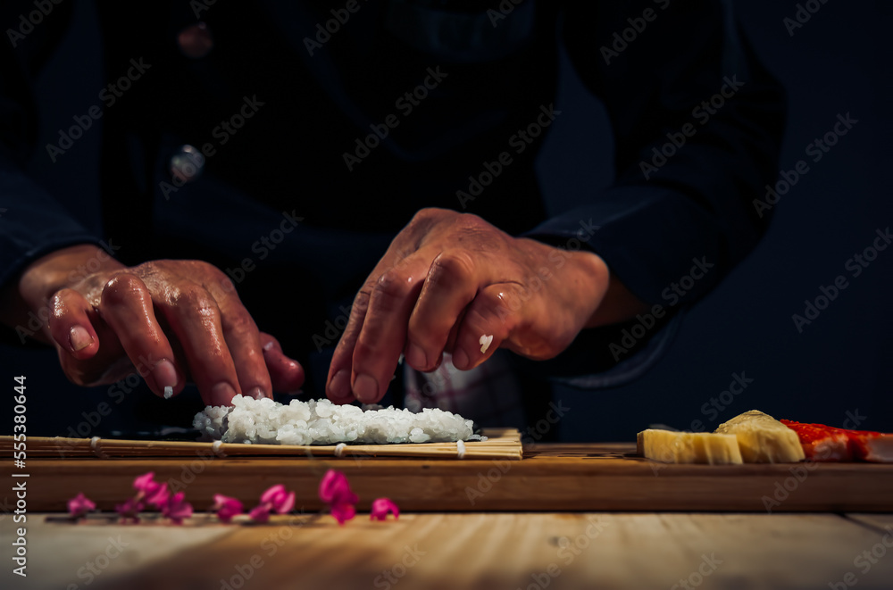 Japanese chef making California Maki Sushi with Masago - Roll made of ...