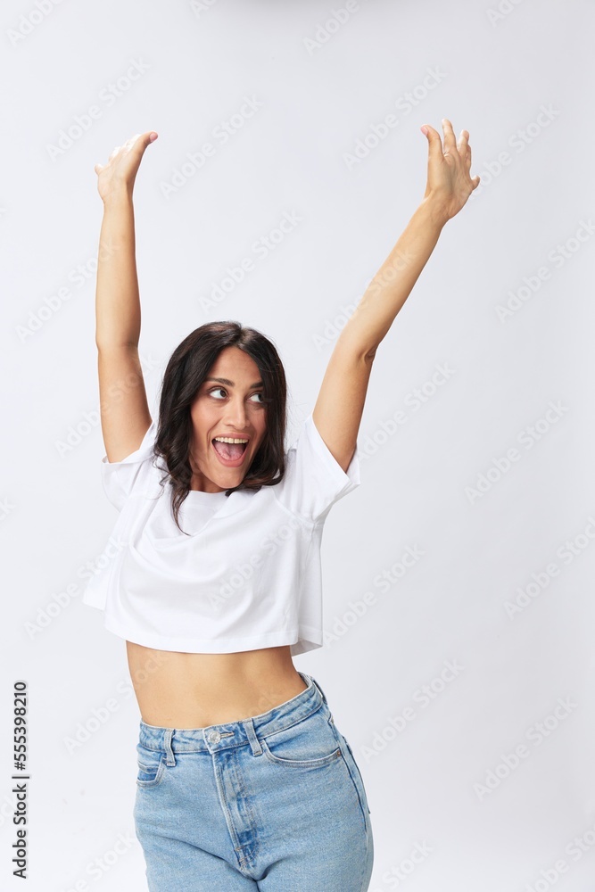Woman in white t-shirt on white background brunette hands up gestures ...