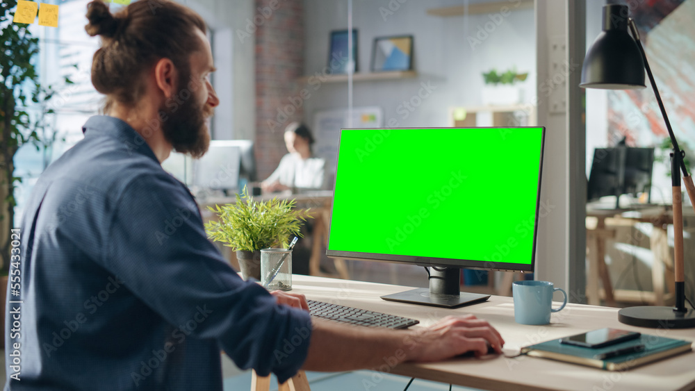Handsome Long-Haired Bearded Manager Working at a Desk in Creative ...