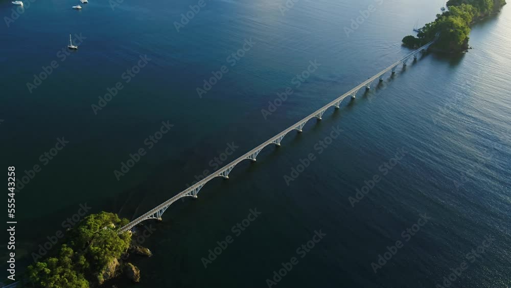 Bridge against the sea. Pedestrian bridge in the Saman Bay. Islands off ...