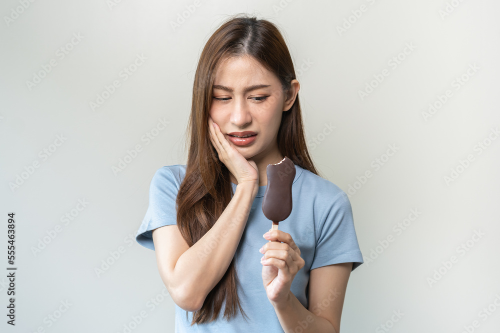 Face expression suffering from sensitive teeth and cold, asian young ...