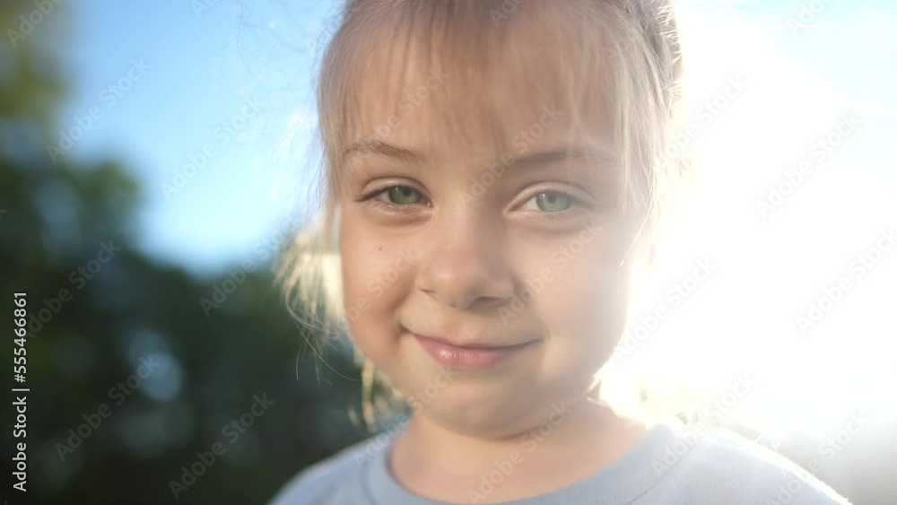 little girl portrait in the park. close-up a girl child in nature ...