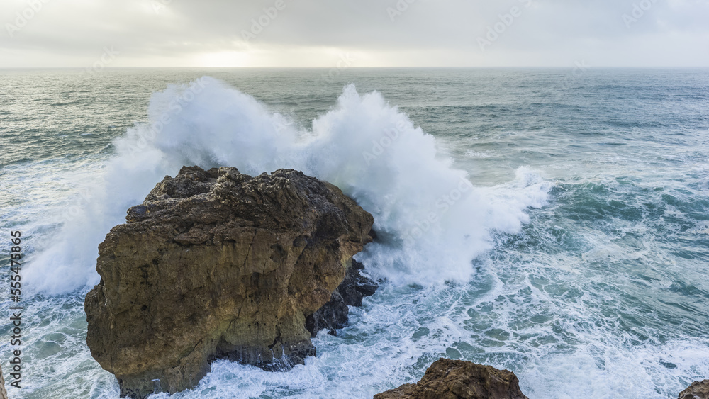 Large wave crashing into a rock along a coast. The biggest waves in the ...