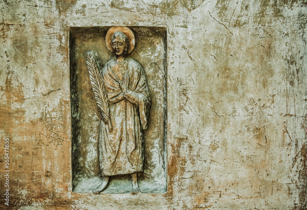 Historic artwork of a man carved in a stone wall in a basilica; Trieste ...