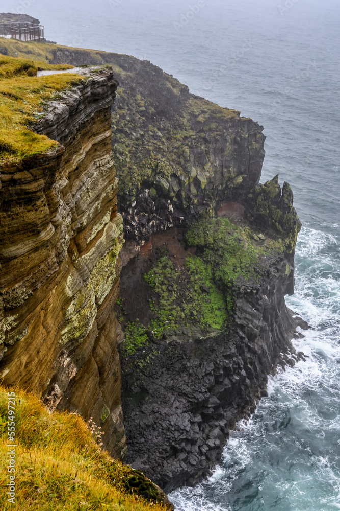 Rugged cliffs along the coast in mist, Snaefellsjokull National Park ...