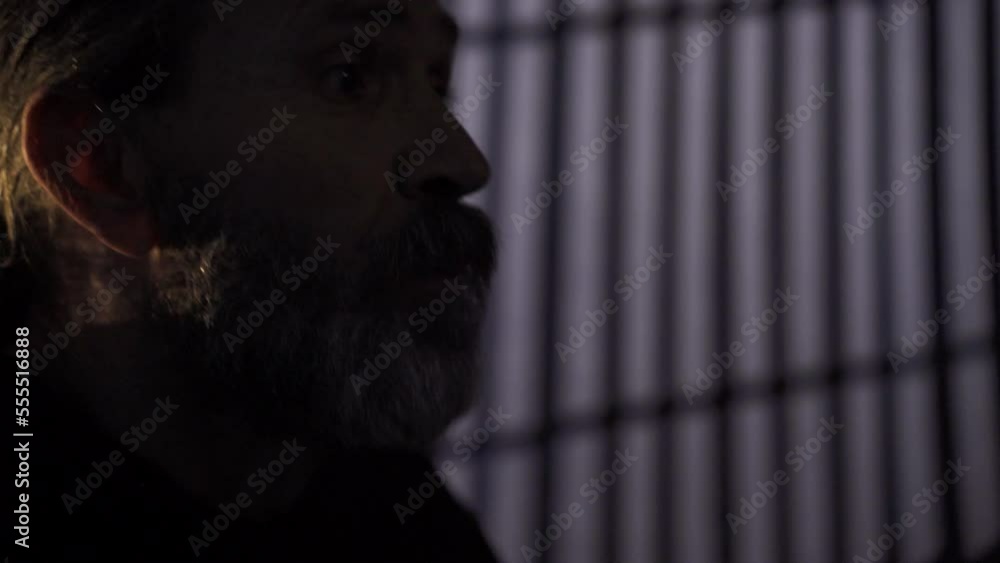 Suspicious guilty man being questioned in prison. Interrogation room ...