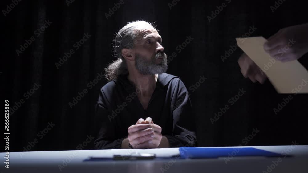 The detective questions the suspect in the interrogation room with his ...