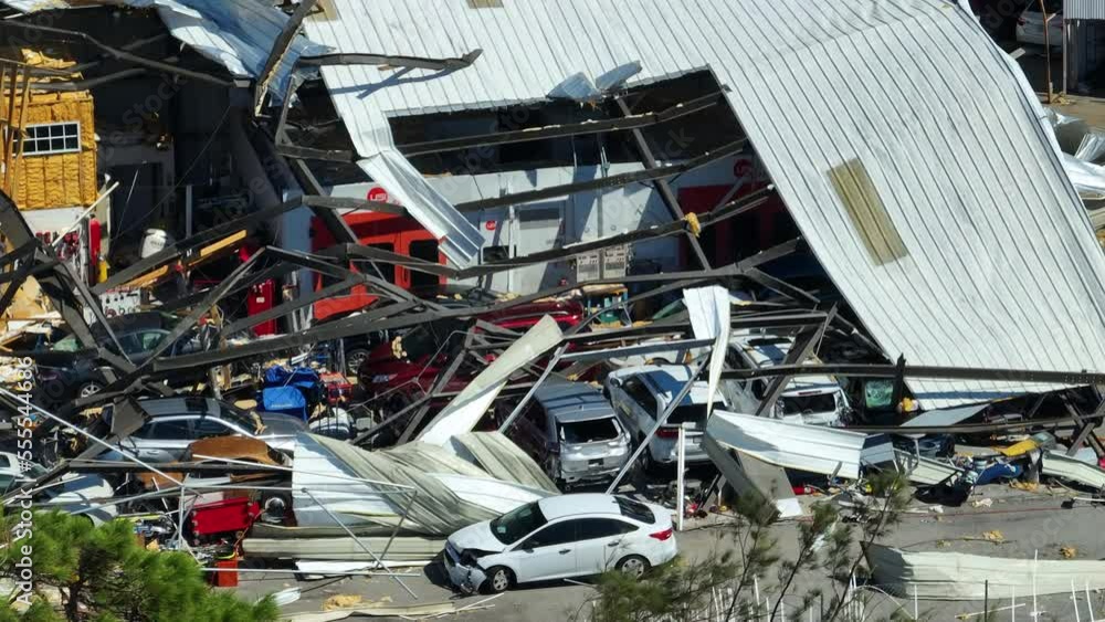 Hurricane Ian destroyed industrial building with damaged cars under ...