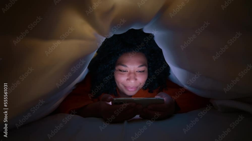Woman of color scrolling feed on smartphone. Slow motion of young ...