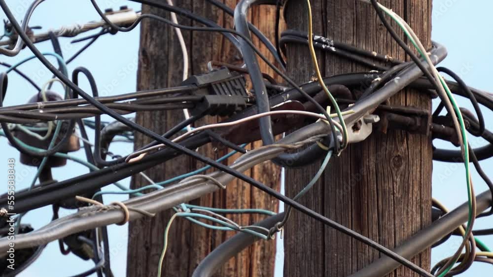 Black fiber optic cables for communication systems hung on the cables ...