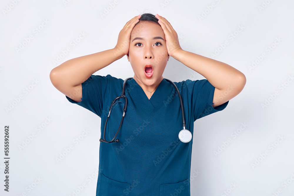 Shocked and anxious Asian woman nurse wearing blue uniform with a ...