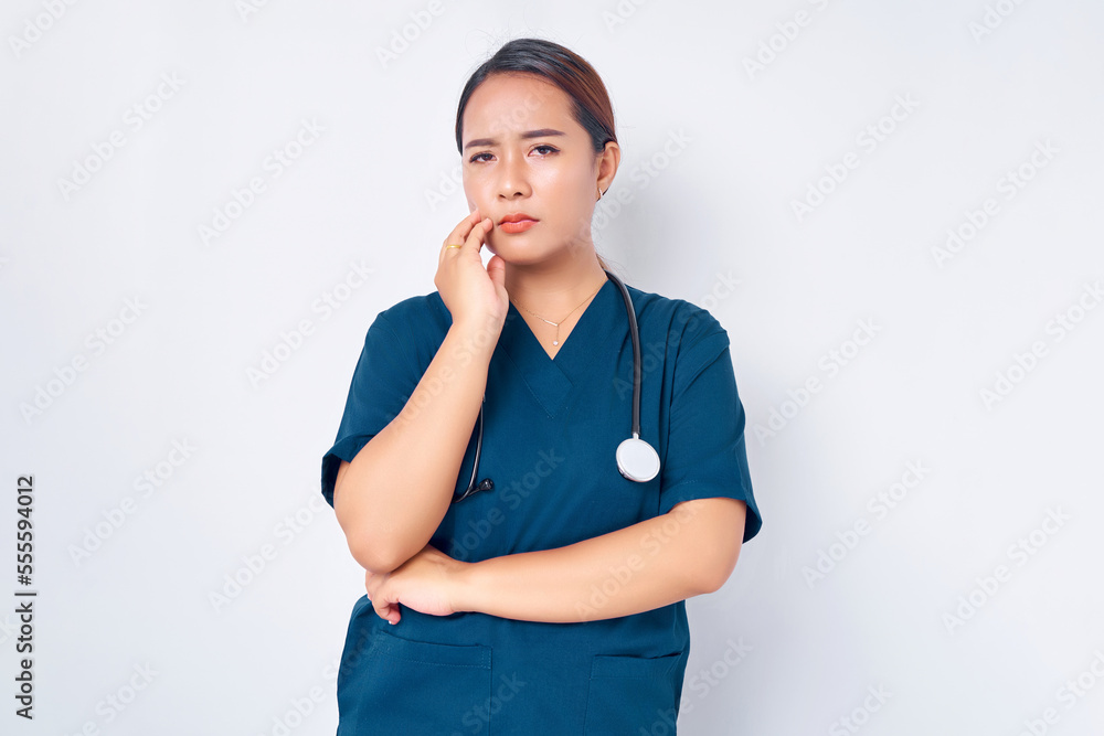 Annoyed and bothered young Asian woman nurse wearing blue uniform with ...