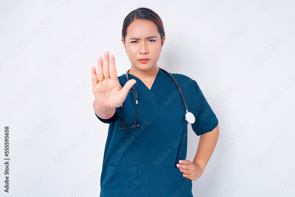 Angry young Asian woman nurse wearing blue uniform with a stethoscope ...