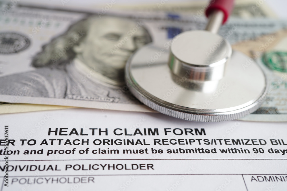 Health claim form with stethoscope and US dollar banknotes, insurance ...