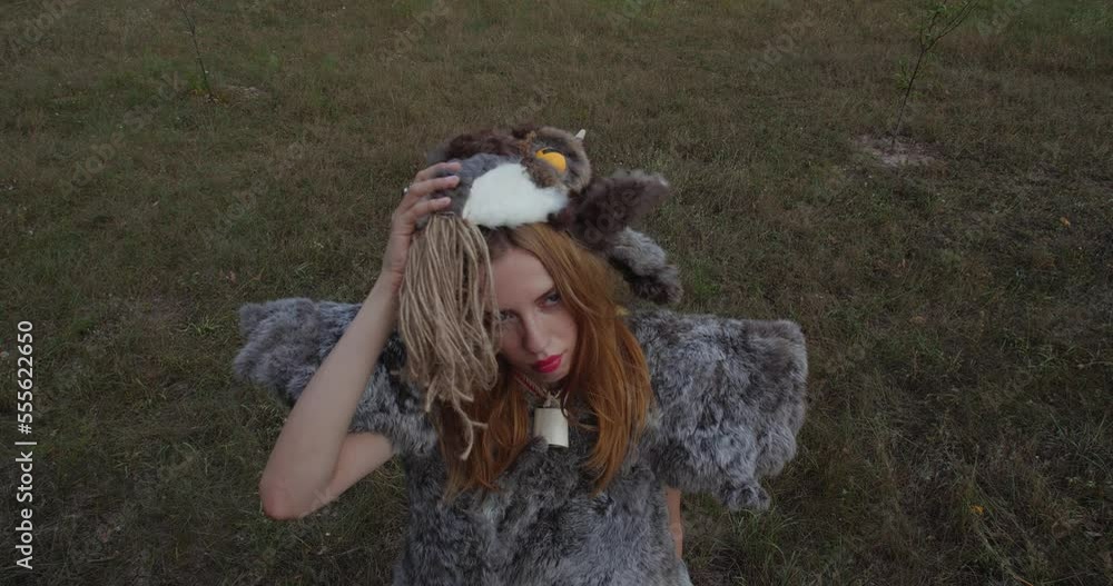 Close up portrait of blonde girl in a pagan animal-like fur made of ...