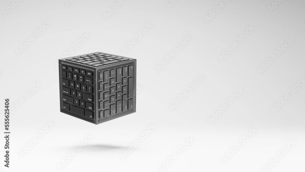 Cube Shape with Computer Keyboard on Faces Spinning on a Studio Light ...