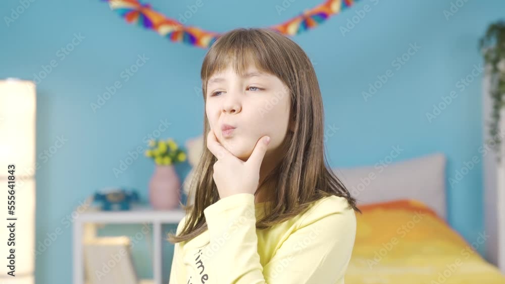 Positive daydreaming, thinking little girl with her hand on her chin ...