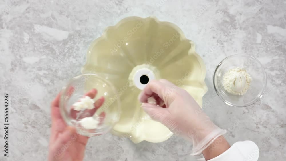 Time lapse. Flat lay. Greasing bundt cake pan with vegetable shortening ...