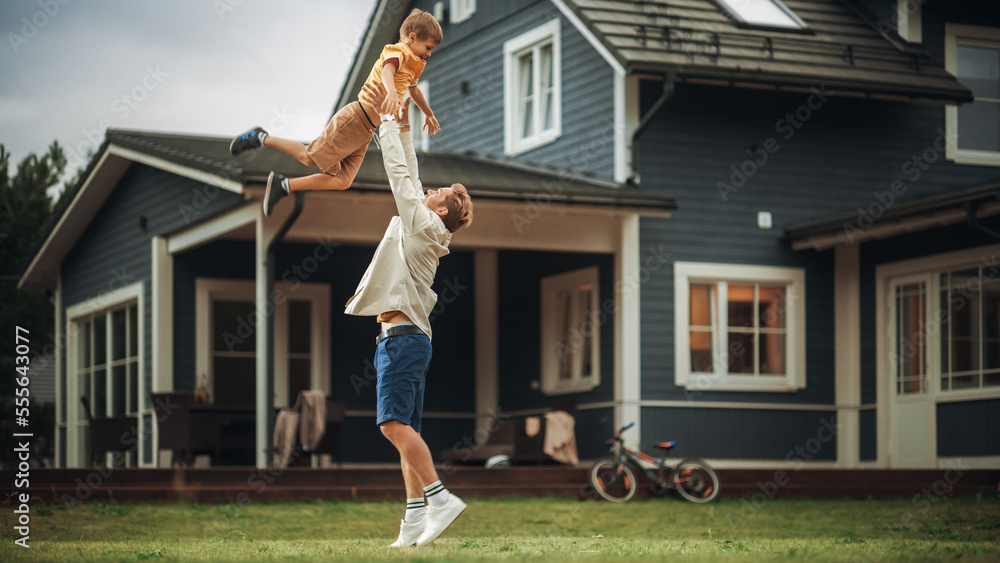 Young Father Playing with His Son Outside the House on the Front Yard ...