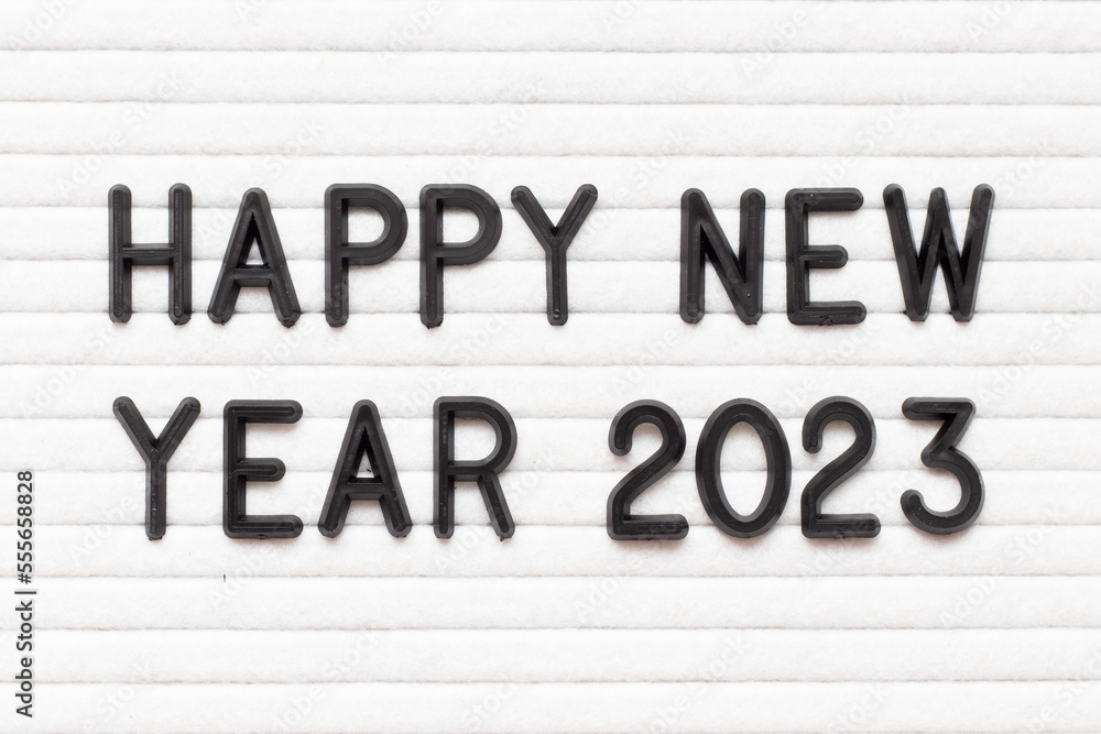 Black color letter in word happy new year 2023 on white felt board ...