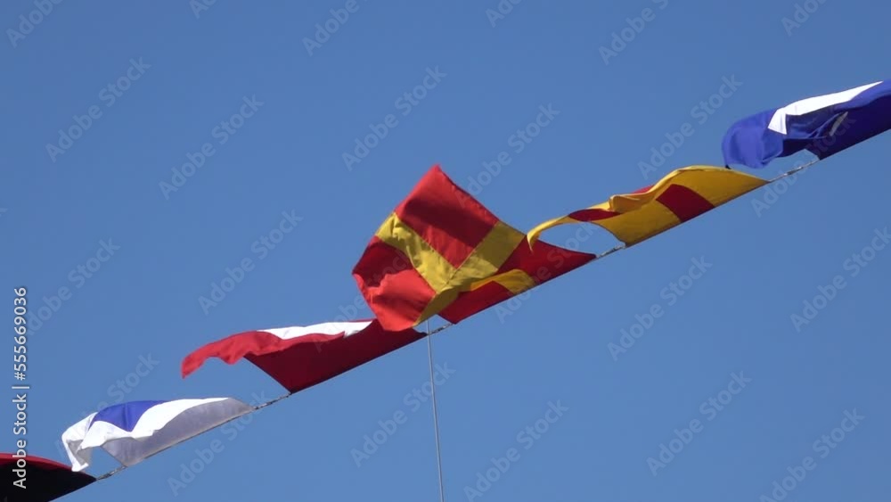 Various nautical flags tied together with rope, Ship flags signals ...