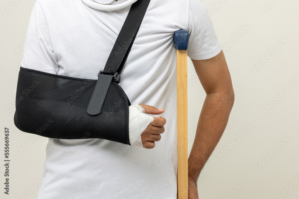 Young man broken arm and leg on isolated. Man put on plaster cast ...