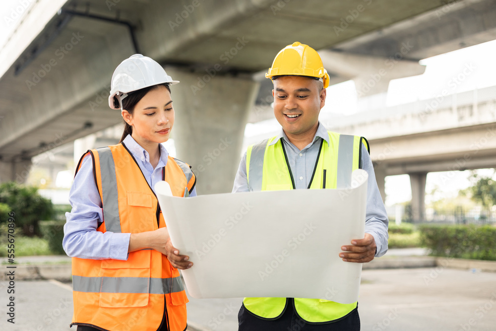 Foto de Two Asian worker engineer man and woman architect looking ...