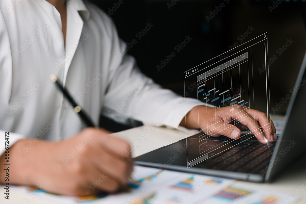 Businessman using laptop with Gantt chart scheduling virtual diagram ...