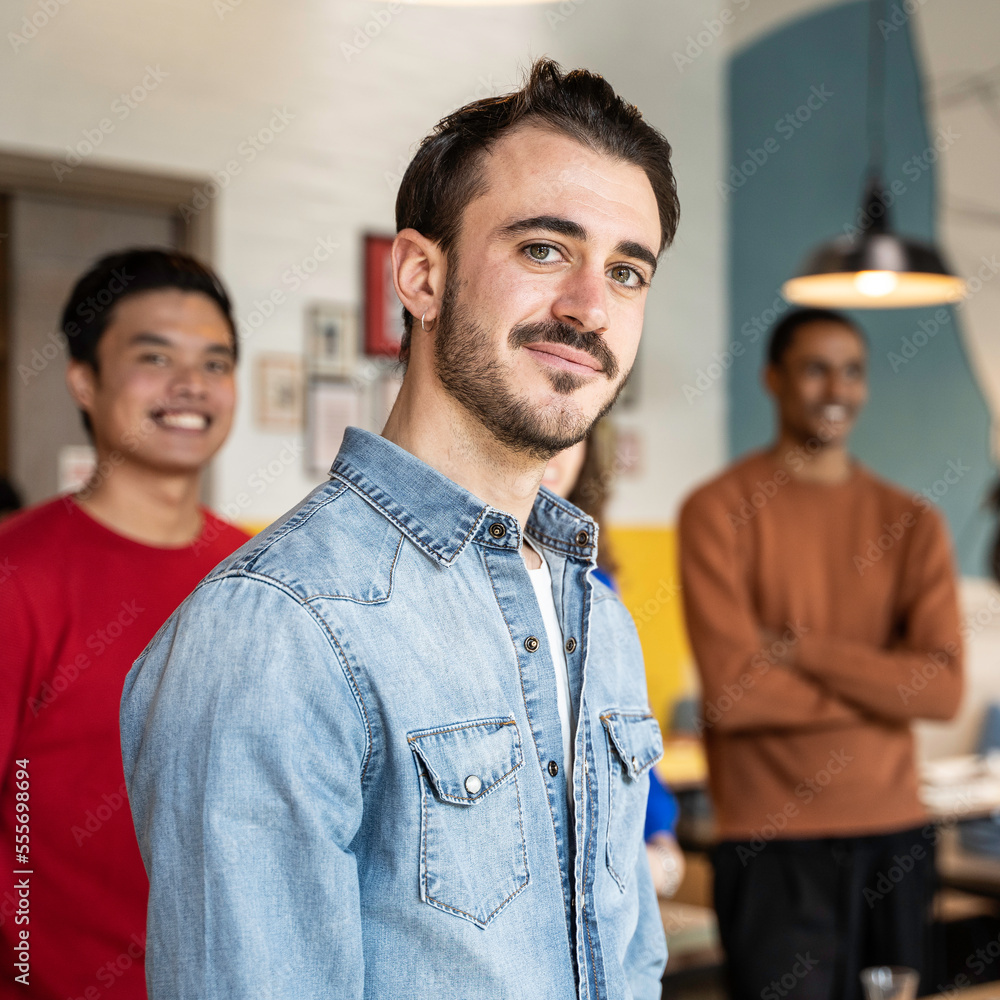 Portrait of young student looking at camera during leisure activity in ...