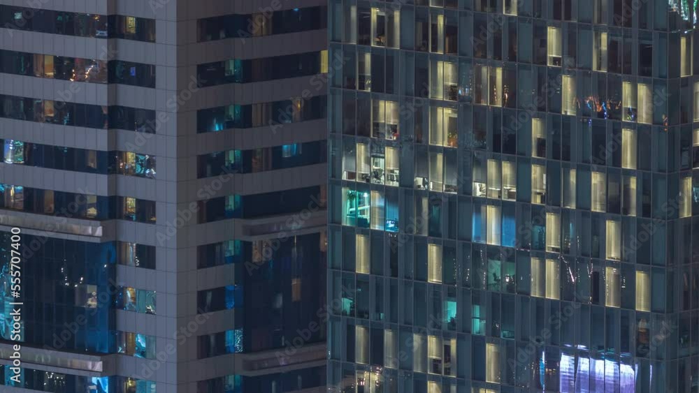 Windows in high-rise building exterior in the late evening with glowing ...