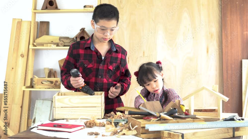 Asian sibling kids having fun play woodwork together, teen boy enjoy ...