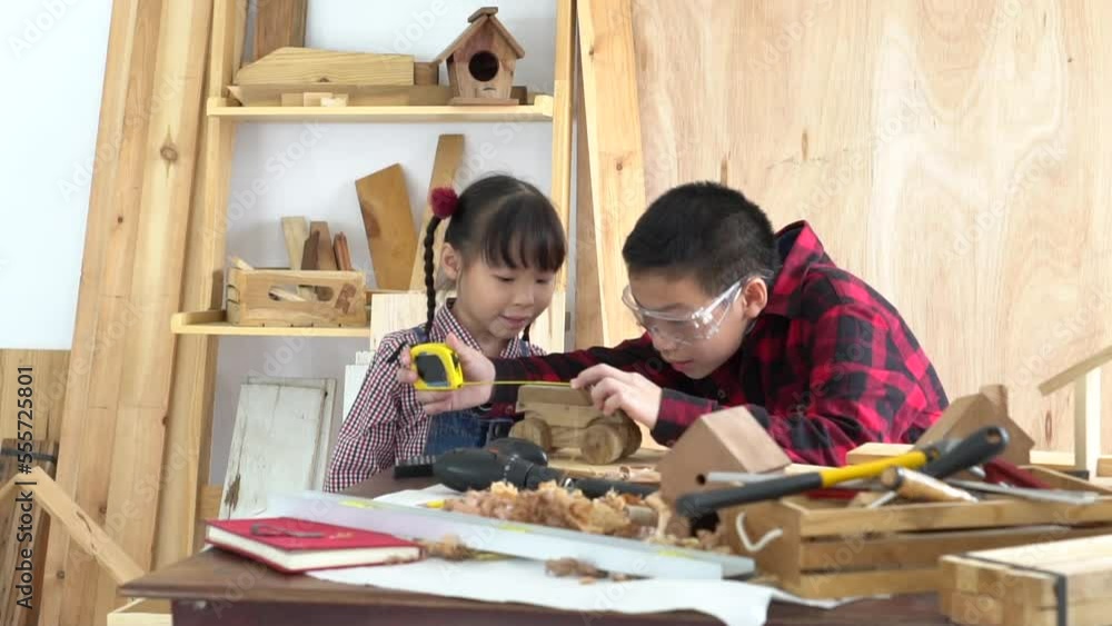 Asian sibling kids having fun play woodwork together, teen boy enjoy ...