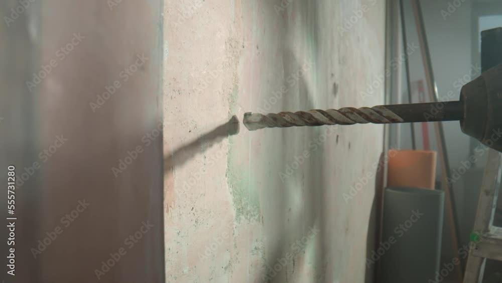Process of drilling hole in concrete wall using electric drill or ...