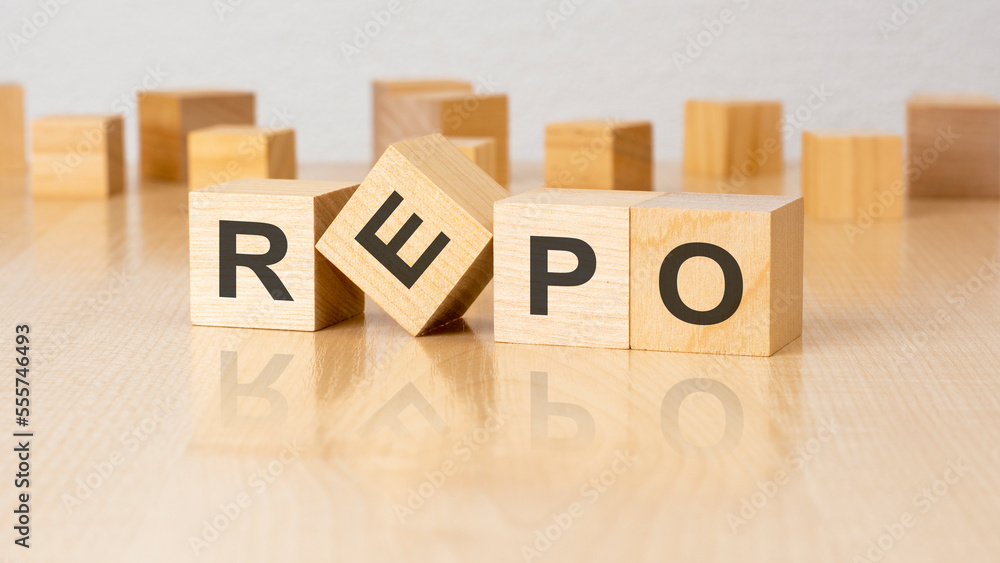 four wooden blocks with text REPO on table. copy space. white ...