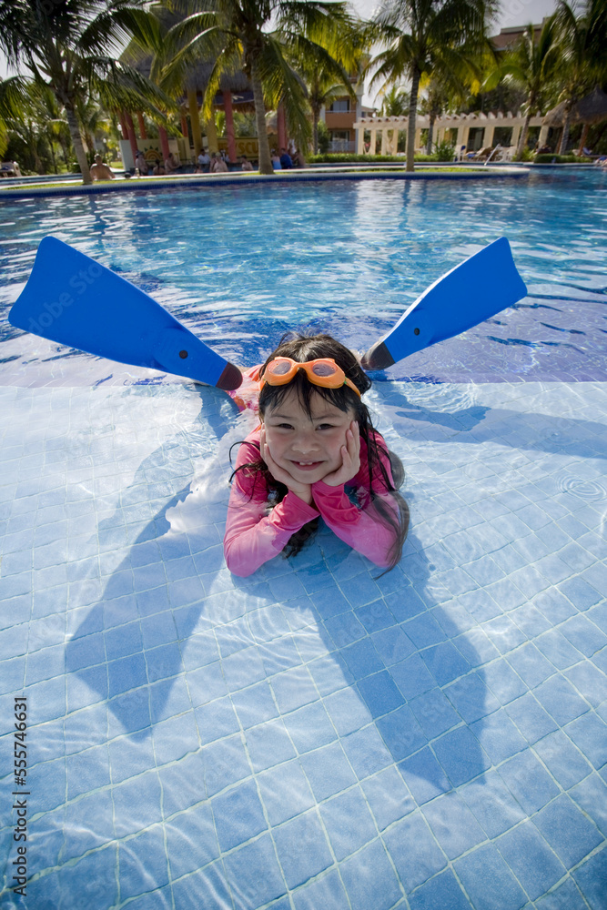 Girl Lying in Swimming Pool Wearing Goggles and Flippers Stock Photo ...