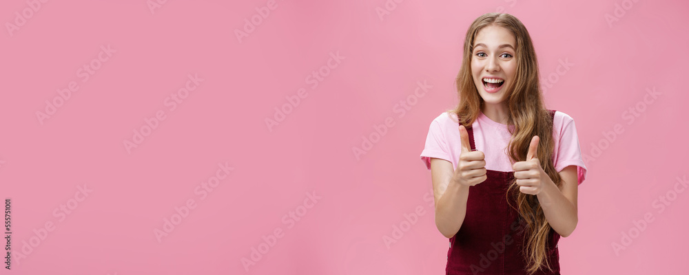 Friendly and outgoing pretty young woman in overalls with wavy natural ...