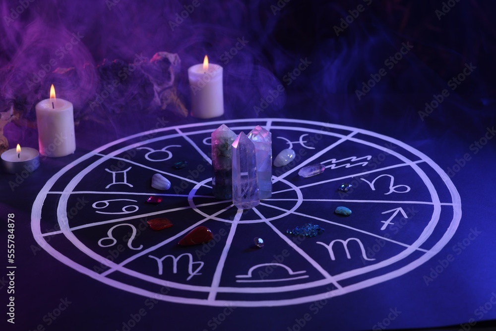 Natural stones for zodiac signs, drawn astrology chart and burning ...
