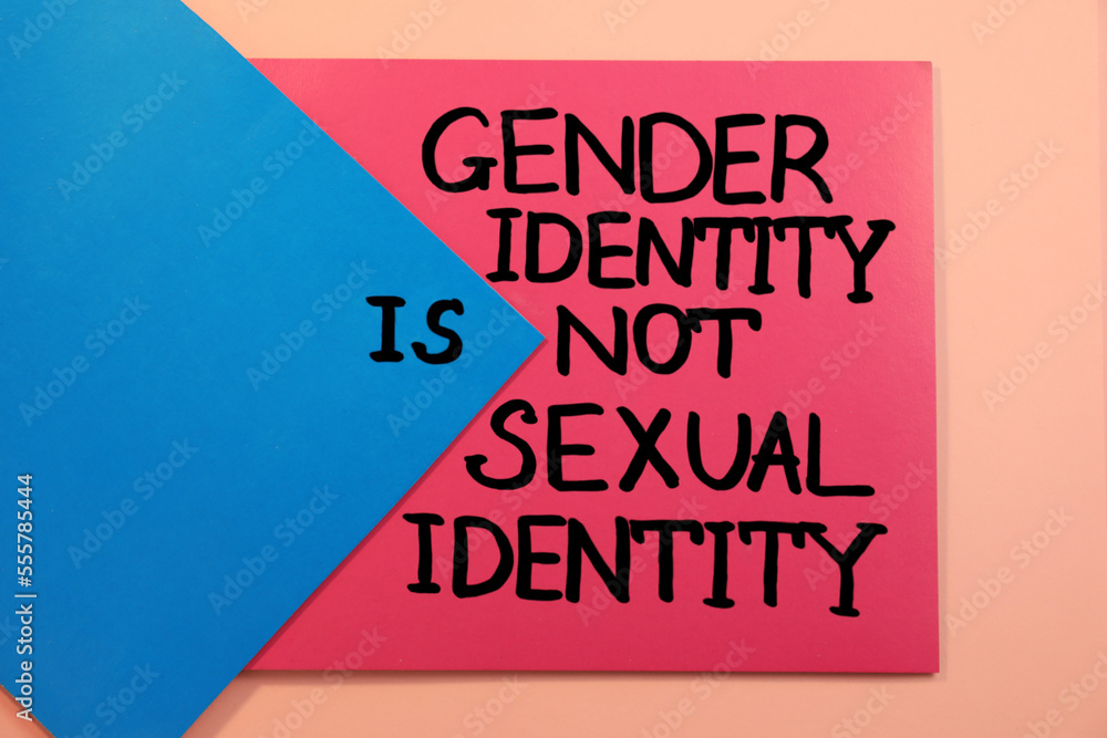 Paper with text Gender Identity Is Not Sexual Identity on pink ...
