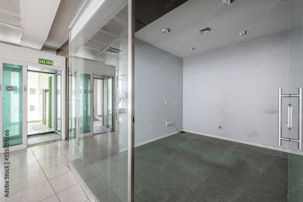 Empty office of a local with dirty carpet and technical ceilings and ...
