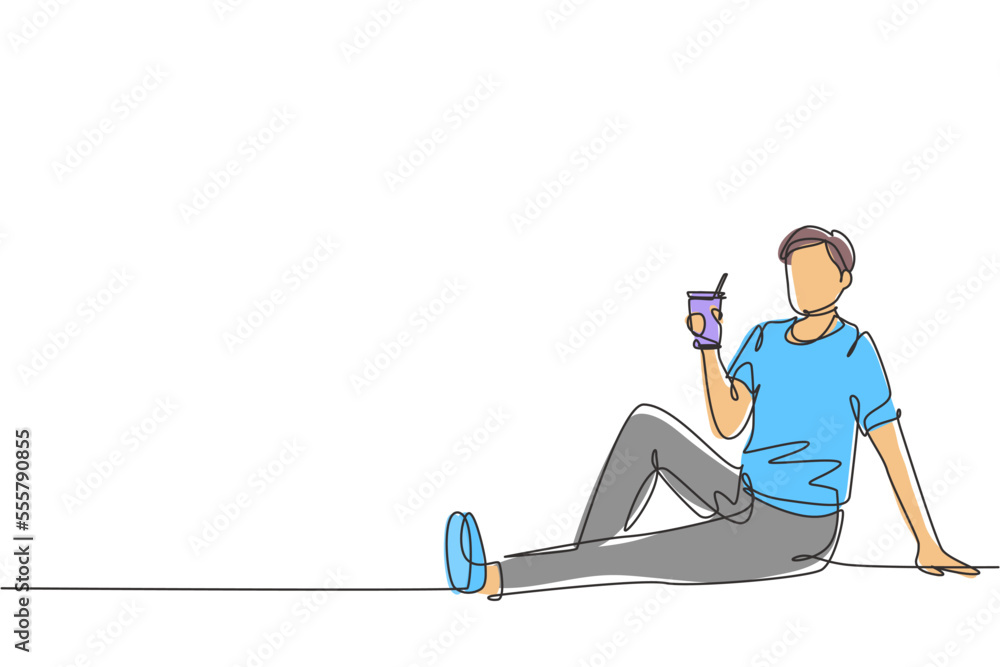 Continuous one line drawing young man sitting relaxed in the park ...